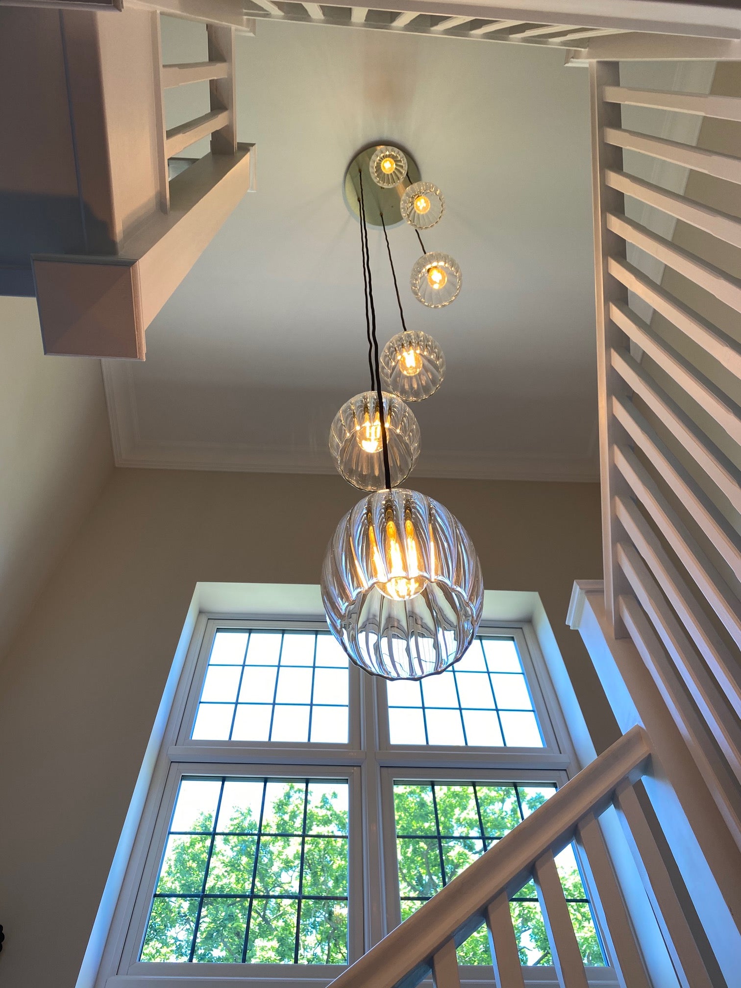 Clear ribbed glass staggered pendant cluster light enhances beautiful ...